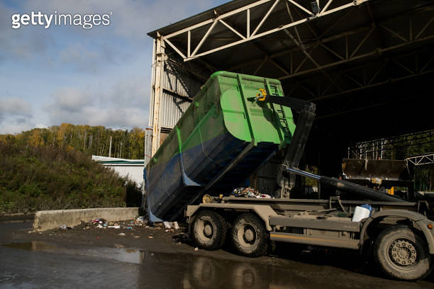 Loading container with waste to a special machine for subsequent ...