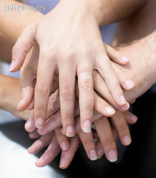 Hands piled up in solidarity pledge (1179548037) - 게티이미지뱅크