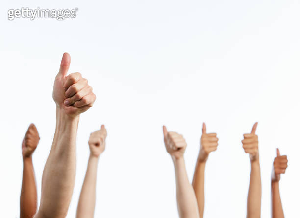 Seven raised hands give enthusiastic hands-up signals on white ...