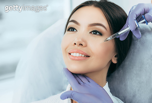Korean woman getting rejuvenation injection for fresh skin. Staying ...