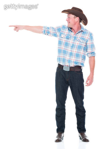 Handsome cowboy is pointing upwards (1134498496) - 게티이미지뱅크