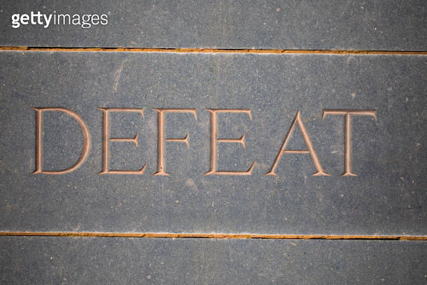 The word ‘DEFEAT’ carved/ chiselled into cracked dark slate/stone. 이미지 ...