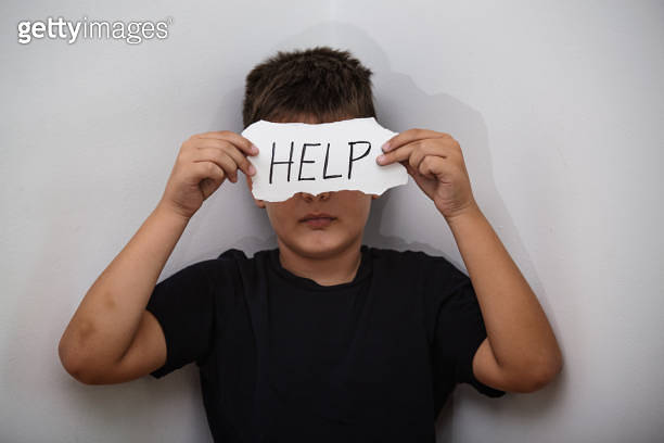 HELP, Teenager with help sign. Boy holding a paper with the inscription ...