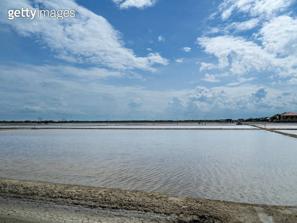 Sea salt fields local farm industry on a beautiful blue sky in Thailand ...