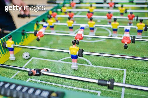 The bride and groom play table football, soccer. Wedding celebration ...