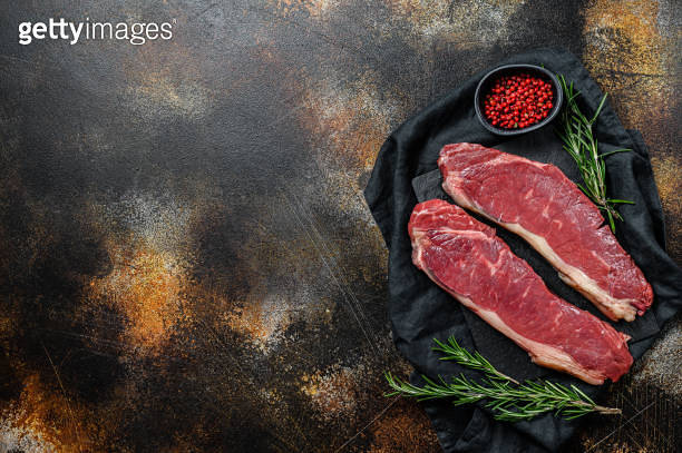 Fresh meat, marbled beef, raw sirloin steak. Dark background. Space for ...