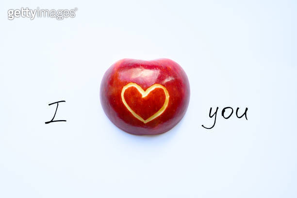Beautiful bright juicy ripe red apple with a heart shaped cut-out, and ...