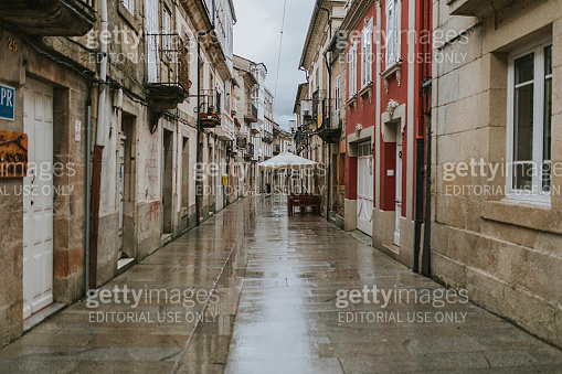 Sarria village center, in a rainy day, with traditional buildings in ...