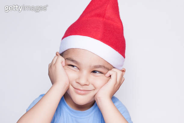 A little kid making funny annoyed face. Kid not happy with Christmas ...