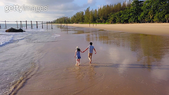 Happy Asian couple dating at the beach during travel honeymoon trip on ...