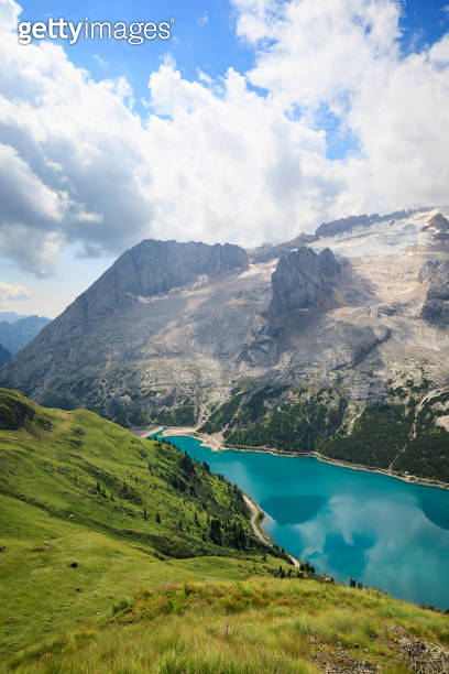 Summer landscape. Beautiful view of lake Fedaia and Marmolada mountain ...