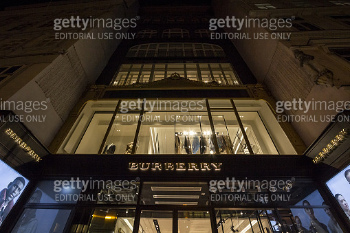 Burberry logo on their boutique for Vienna, at night. Burberry is a ...