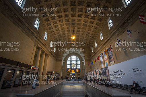 Toronto main hall with its departures and arrivals board & passengers ...