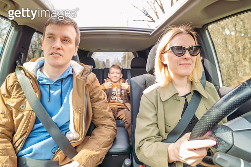 young family with little boy kid inside car. road trip concept ...