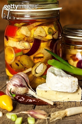Cheese pickled in olive oil. Home-made pickled cheese. Jar with ...
