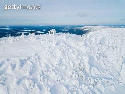 Aerial view of winter snow covered wood hut. Frozen log cabin in ...
