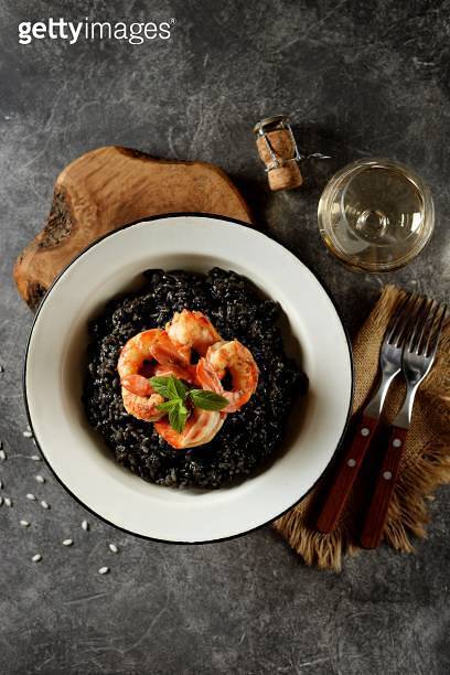 Delicious Italian risotto with grilled big tails of shrimp and ...