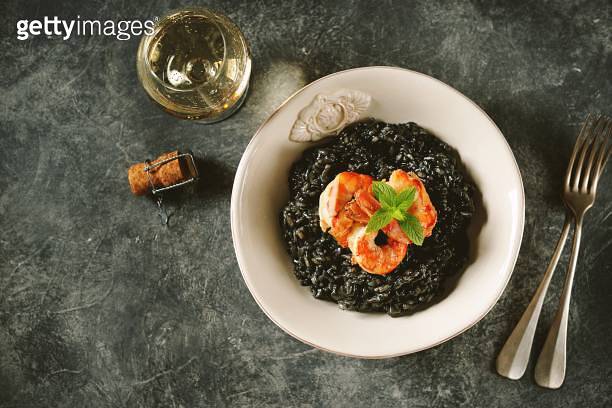 Delicious Italian risotto with grilled big tails of shrimp and ...