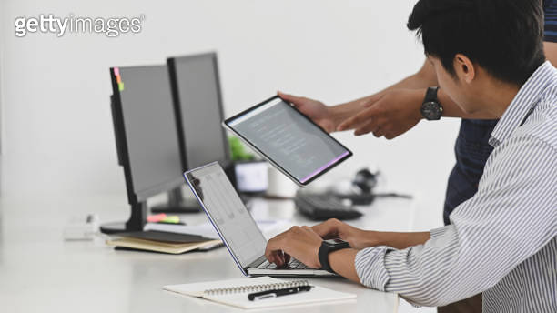 Two male programmers working on new project.They working with computer and tablet. 이미지 ...