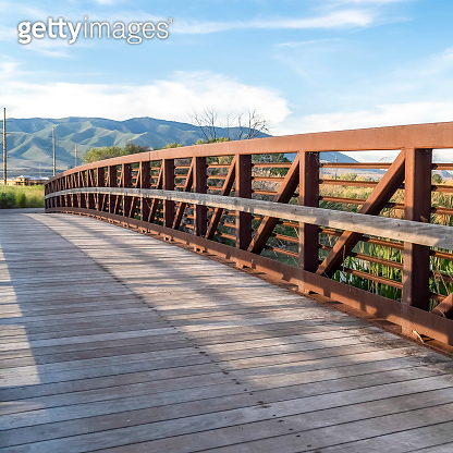 Square frame Bridge over a lake with view of mountain and valley under ...