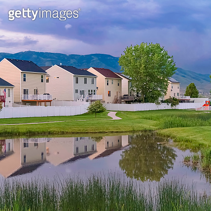 Square frame Shiny pond and pathway amid a grassy terrain in front of ...