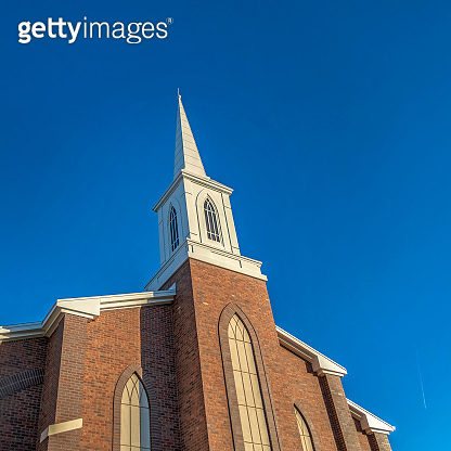 Square frame Church with classic red brick exterior wall and white ...