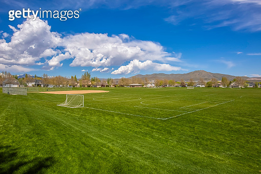 Soccer field and baseball field with view of mountain and cloudy blue ...