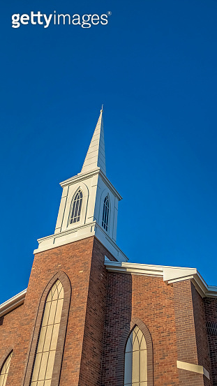 Vertical frame Church with classic red brick exterior wall and white ...