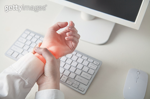 Business girl with pain on the wrist. Work in computer. Office syndrome ...