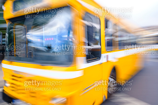 Yellow bus driving on the street in Funchal on Madeira island. Photo ...