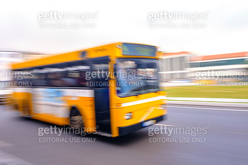 Yellow bus driving on the street in Funchal on Madeira island. Photo ...