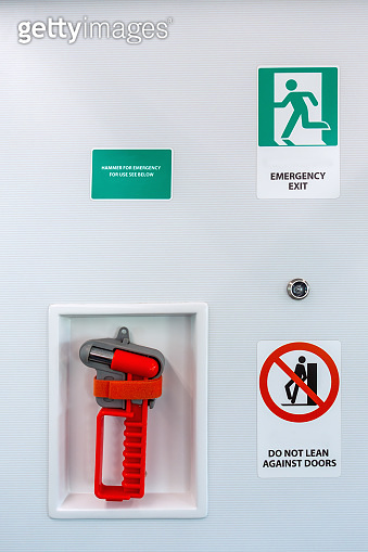 Emergency signs or symbol and window breaking hammer in public ...