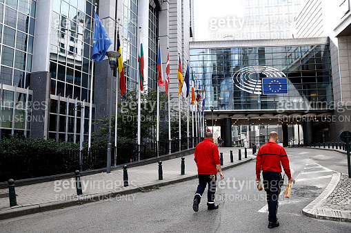 People walk outside of European Parliament building in Brussels ...