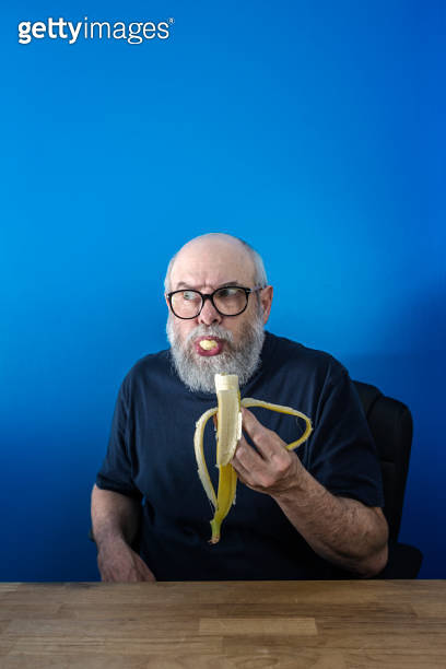 Humorous Suspicious Office Worker Slob Eating Banana and Listening ...