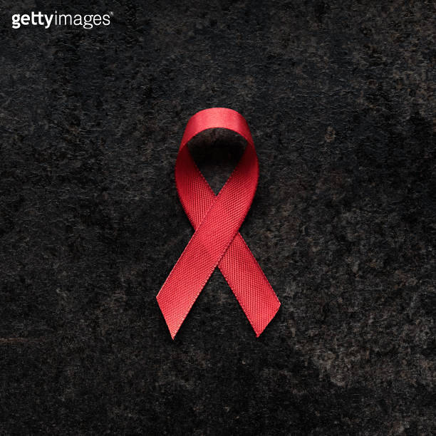 AIDS awareness red ribbon on dark background 이미지 (1168893886) - 게티이미지뱅크
