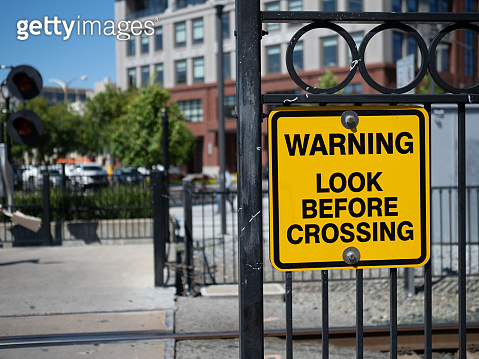 Warning look before crossing yellow warning sign at train crossing in ...