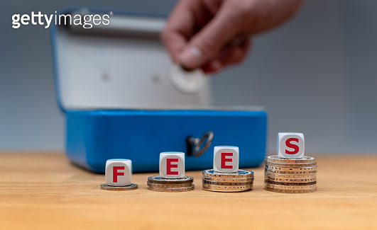 Symbol for increasing fees. Dice placed on stacks of coins form the ...