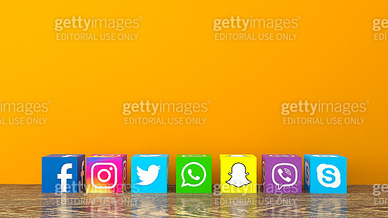 Social media services icons with on wooden desk with an orange color ...