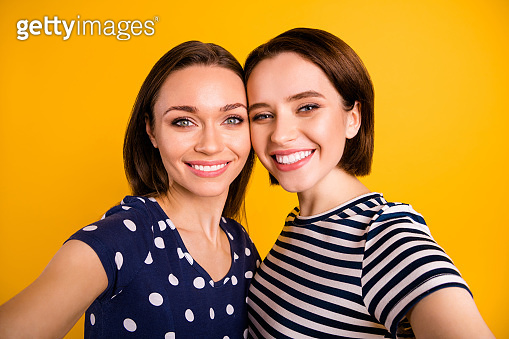 Close up photo of two amazing ladies making selfies toothy beaming ...