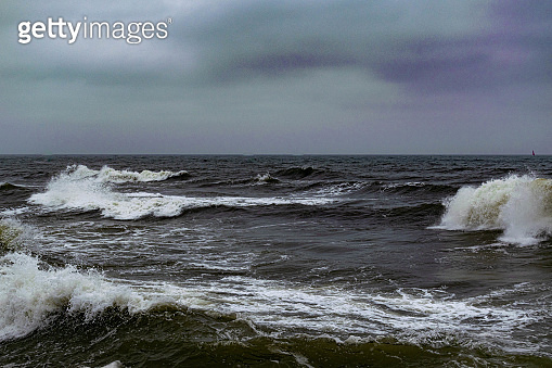 Angry waves in the ocean with strong currents and a moody sky. Beach ...