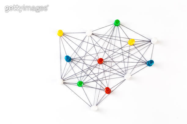 Network connection made from push pins and thread on blue background ...