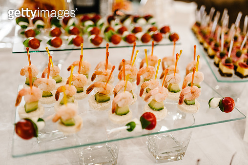 Assorted mini canapes on table. Restaurant food at event. Delicacies ...