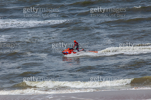 a member of the dutch coastguard "Reddingsbrigade" on a jet ski in the ...