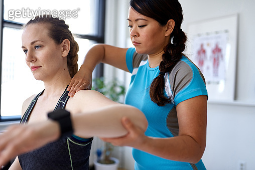 Chinese woman physiotherapy professional giving a treatment to an ...