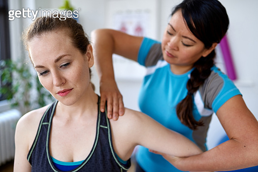 Chinese woman physiotherapy professional giving a treatment to an ...
