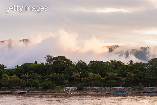 In the morning, the sun rises on the banks of the Mekong River in the ...