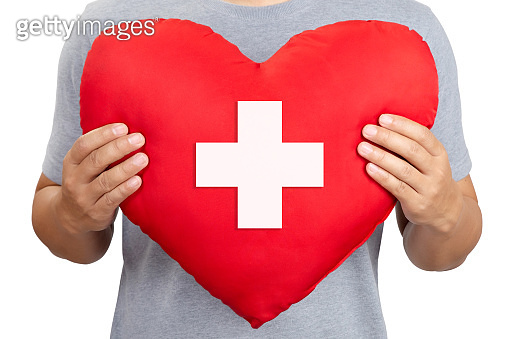 Red heart with cross sign in male hand, close-up.International Red ...