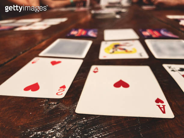 Golf Card Game on Rustic Wood Dining Table with decks of playing cards ...