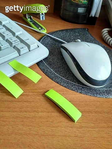 Office workplace with keyboard, color stickers, computer mouse and ...
