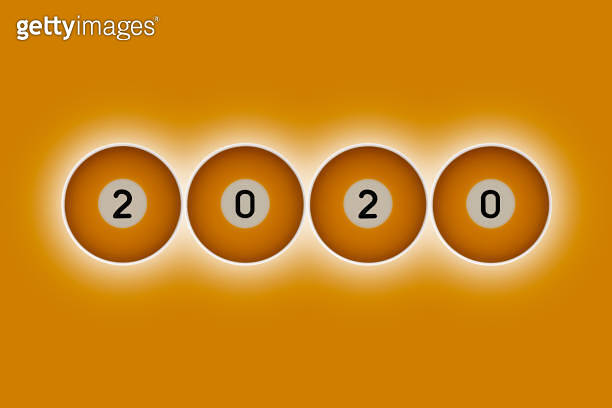 2020 message spelt out with yellow pool balls with a background glow on ...